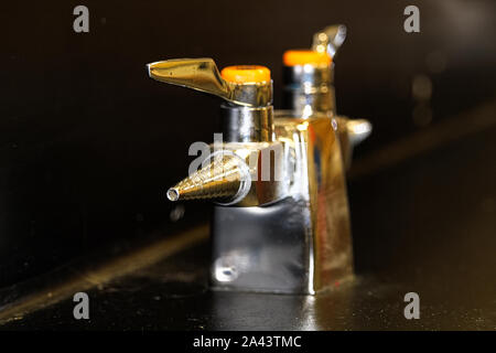 A lab gas valve on a black table and background Stock Photo - Alamy