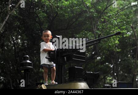 Citizens pose to photo with warcraft, tank, machine gun and other army ...