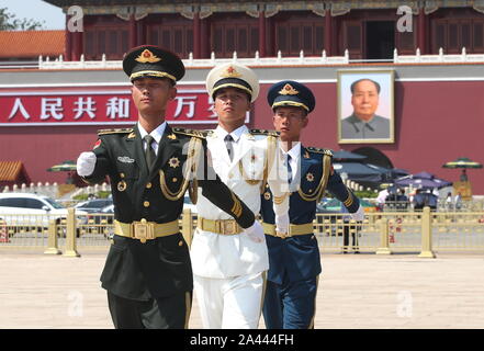 A soldier, a sailor and an airman patrol at the Tian'anmen Square to ...