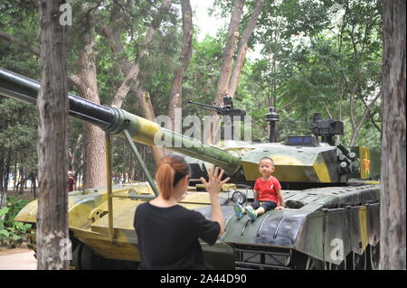 Citizens pose to photo with warcraft, tank, machine gun and other army ...