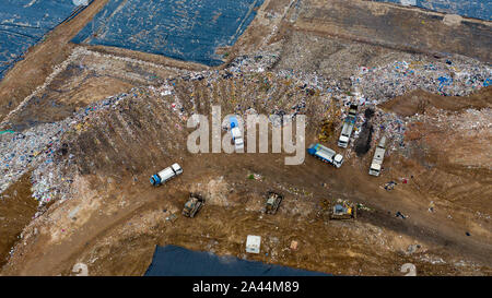 Chinese workers sort out and bury kitchen waste at the Jiangcungou ...