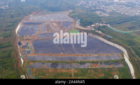Chinese workers sort out and bury kitchen waste at the Jiangcungou ...