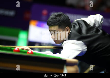 Zhao Xintong of China plays a shot against Ding Junhui of China during ...