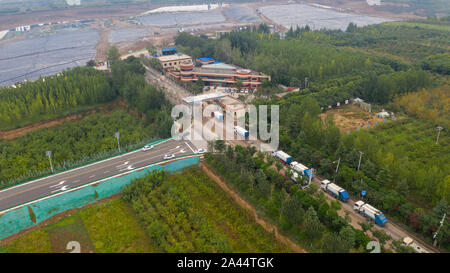 Chinese workers sort out and bury kitchen waste at the Jiangcungou ...
