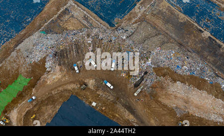 Chinese workers sort out and bury kitchen waste at the Jiangcungou ...