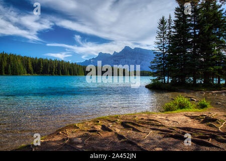Beautiful Two Jake Lake on a sunny day with clouds in the sky and Mount ...
