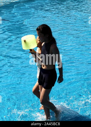 A local resident enjoys huge ice-sucker on a scorching day at a ...
