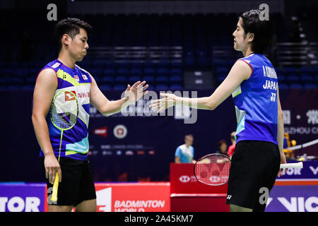Chinese professional badminton players Wang Yilv and Huang Dongping compete against Japanese ...