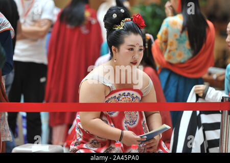 Beauties dressing in ancient Chinese clothes prepare to demonstrate and ...