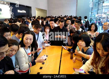 The Apple retail store is crowded with fans waiting to experience the ...
