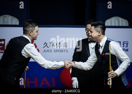 Kyren Wilson (left) shakes hands with John Higgins as he ends the ...