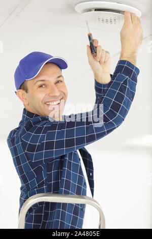 Man fitting an air vent Stock Photo - Alamy