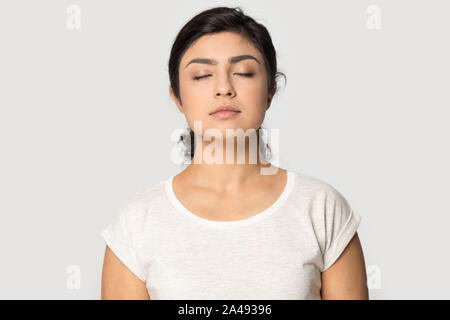 Calm indian girl meditate breathing fresh air at workplace Stock Photo ...