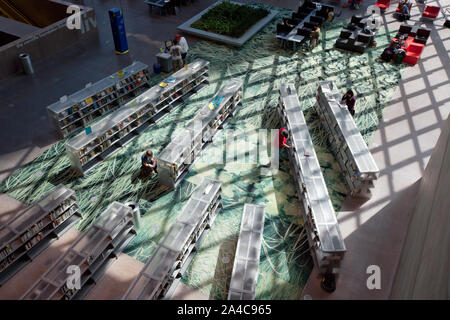 Interior view of Seattle Central Library with sloped glass roof ...