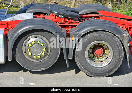 Semi Truck Wheels Closeup on asphalt road highway at sunset ...