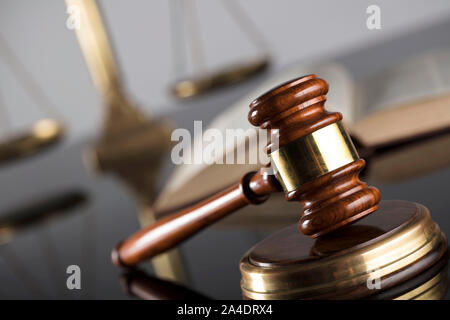 Justice gavel and golden paragraph symbols with many books in ...