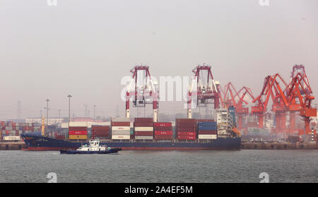 A container ship arrives at Qingdao Port in east China's Shandong ...