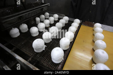 Palestinian workers prepare the vanilla candy known as "crimbo or Ras ...
