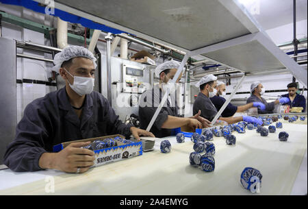 Palestinian workers prepare the vanilla candy known as "crimbo or Ras ...