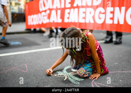 child draws with chalk on the pavement. Selective focus Stock Photo - Alamy