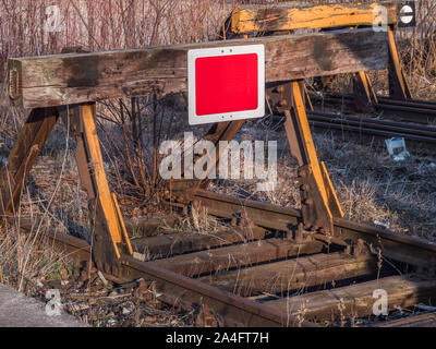 wooden buffer stop with red stop sign ending rail tracks concept for ...