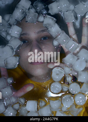 Ice cubes under water, blue color Stock Photo - Alamy