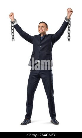 Businessman with shackles on white Stock Photo - Alamy