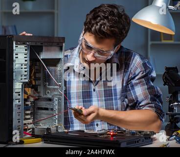 Man repairing computer desktop with pliers Stock Photo - Alamy