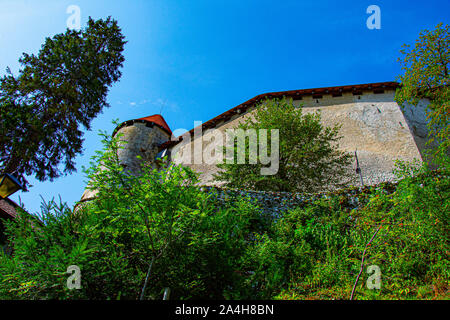 Lake Blade with a Bled Castle, in a frame of leaves in summer day time ...