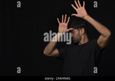 man with seasonal disorder blocking light with hands Stock Photo - Alamy