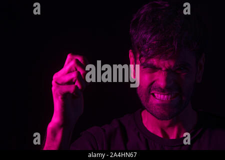 portrait of an angry man with clenched teeth in red Stock Photo - Alamy