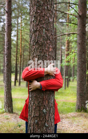 Woman hugging a tree - tree hugger/tree huggers Stock Photo - Alamy
