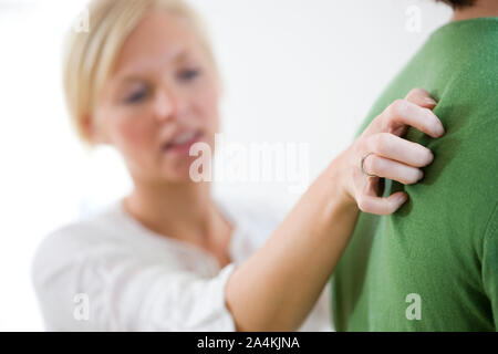 Woman is scratching a mans back Stock Photo - Alamy