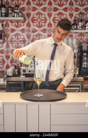 the waiter pours an alcoholic drink, vodka into a glass Stock Photo - Alamy