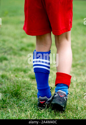 Boy playing football in a back yard Stock Photo - Alamy