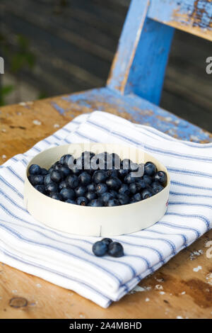 Blueberries in wooden bowls on wooden table Stock Photo - Alamy