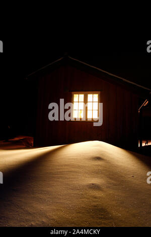 Lights shining through the window of a house at night Stock Photo - Alamy
