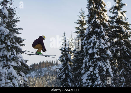 Skier flying through snow Stock Photo - Alamy