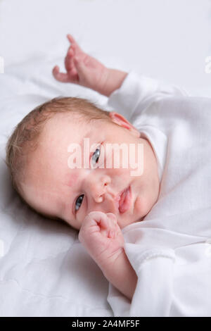 Shot of a newly born baby boy laying down on the pattern sheets Stock Photo - Alamy