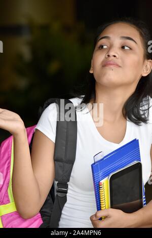Undecided Cute Minority Person With Notebooks Stock Photo - Alamy