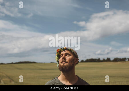 Man wearing flower wreath Stock Photo - Alamy