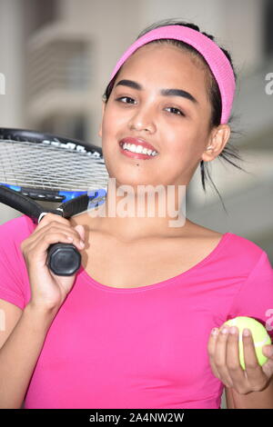 An able-bodied female tennis player awards a gold medal to a smiling male wheelchair athlete on ...