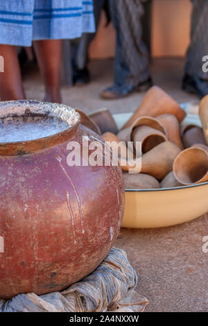 African outdoors kitchen big pots with traditional brewed beer in a ...