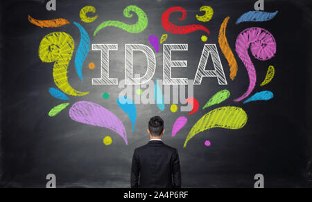 businessman drawing colorful light bulb Stock Photo - Alamy