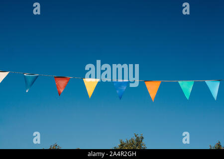 Colorful triangle bunting flags of various colors as festival concep ...