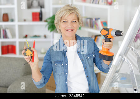 Mature woman doing DIY Stock Photo - Alamy