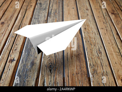Paper plane origami flying over textured wooden table and open laptop ...