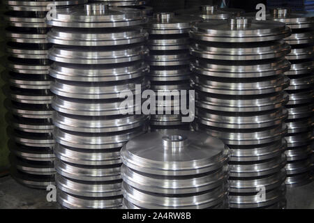stacked steel pulleys inside factory Stock Photo - Alamy