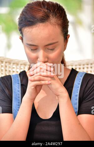 An A Praying Youthful Asian Female Stock Photo - Alamy