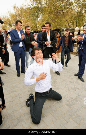 Uzbek People Dancing In The Street, Khiva, Uzbekistan Stock Photo - Alamy